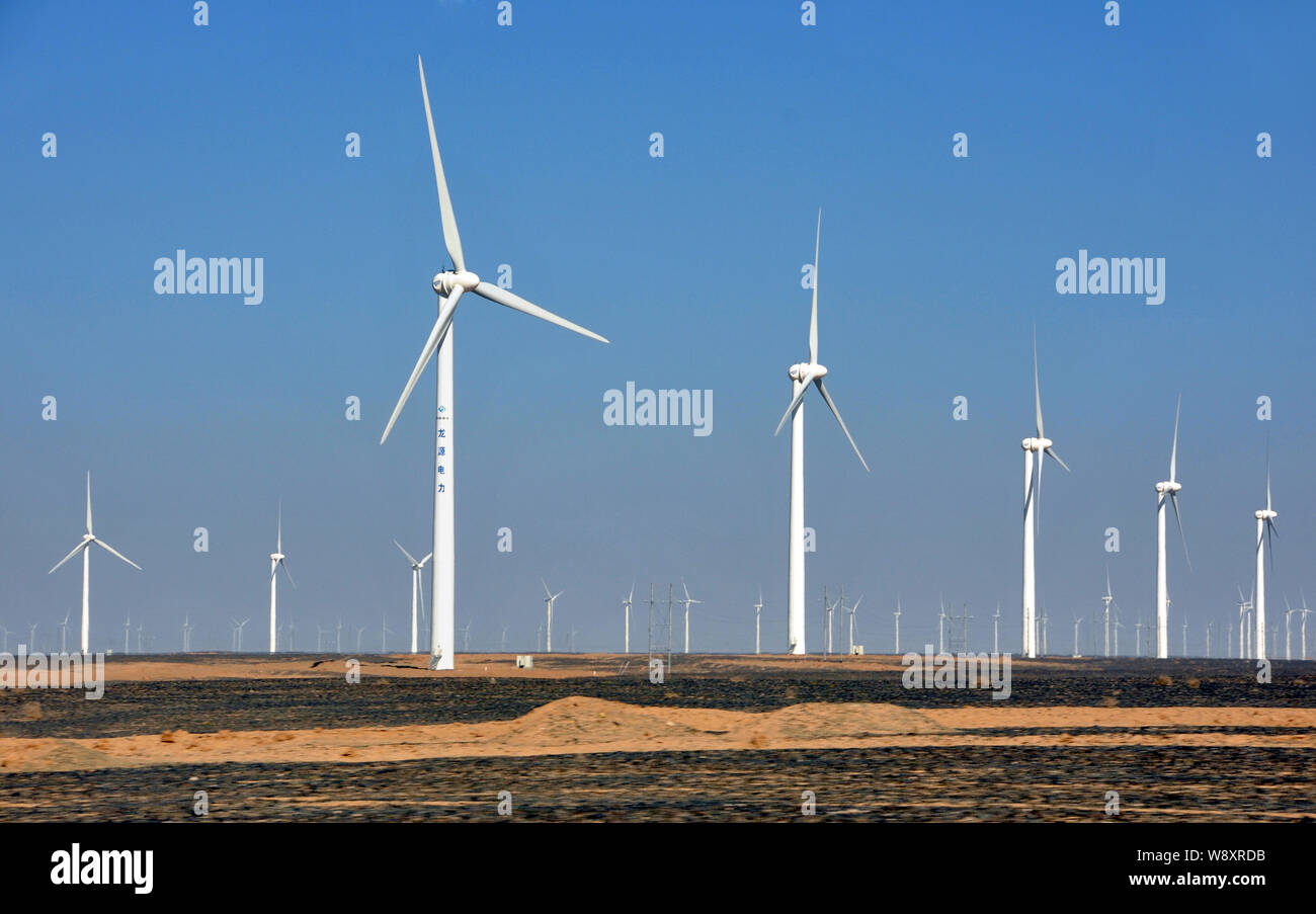 --FILE--Wind turbines whirl to generate electricity at a wind farm in ...