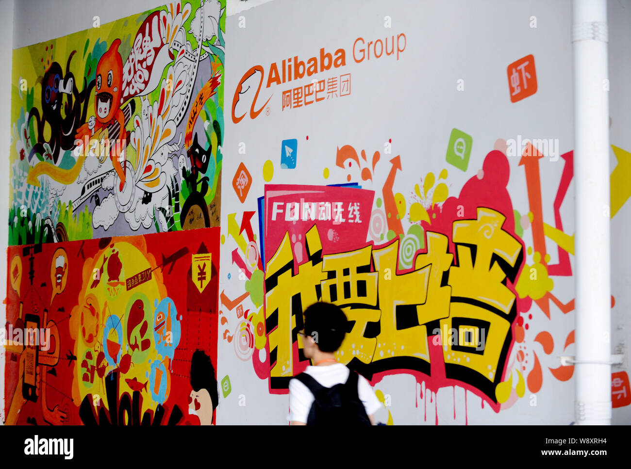 A pedestrian walks past an advertisement for Alibaba Group in Hangzhou ...