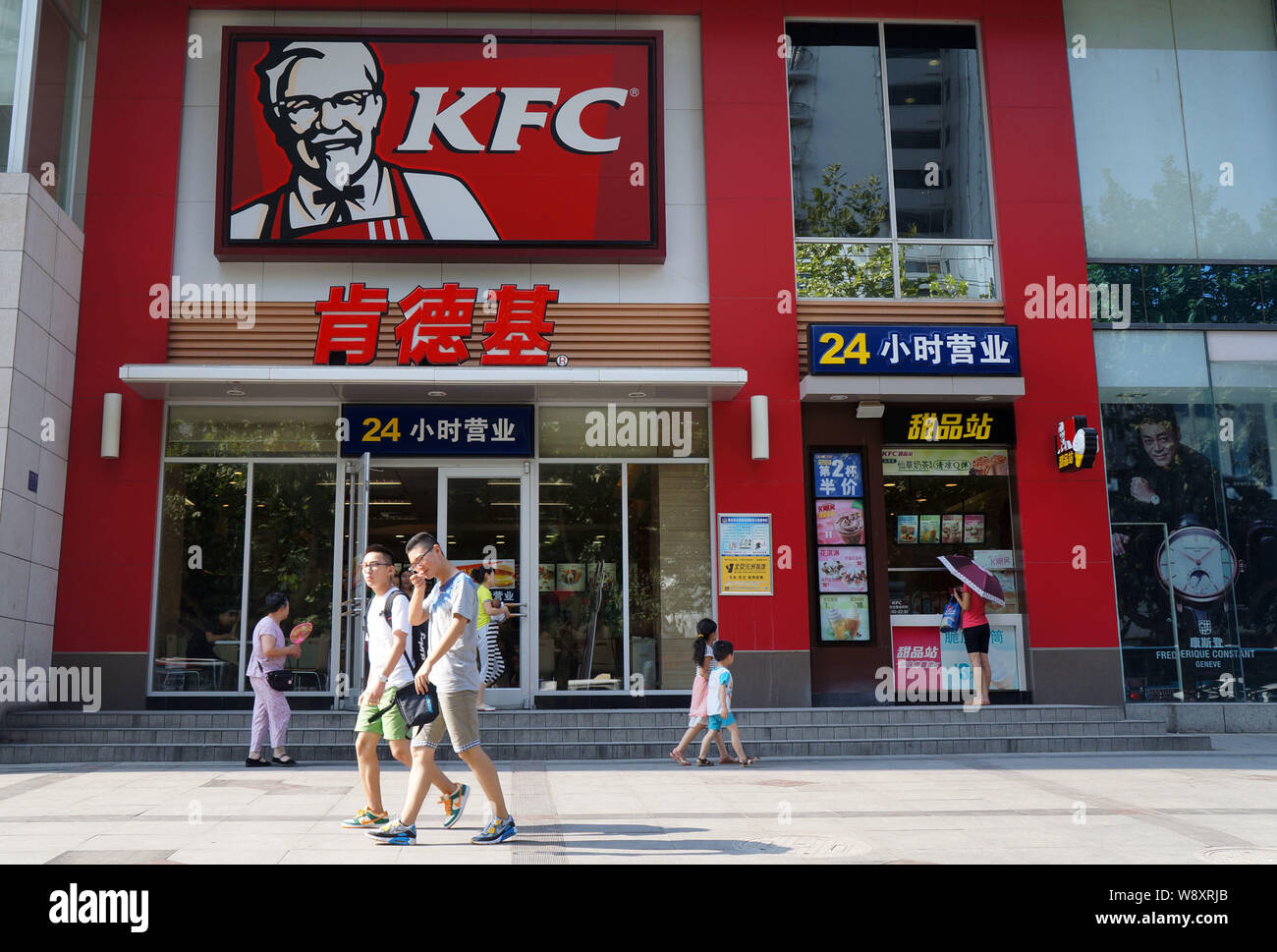 Pedestrians walk past a KFC fastfood restaurant of Yum Brands in ...
