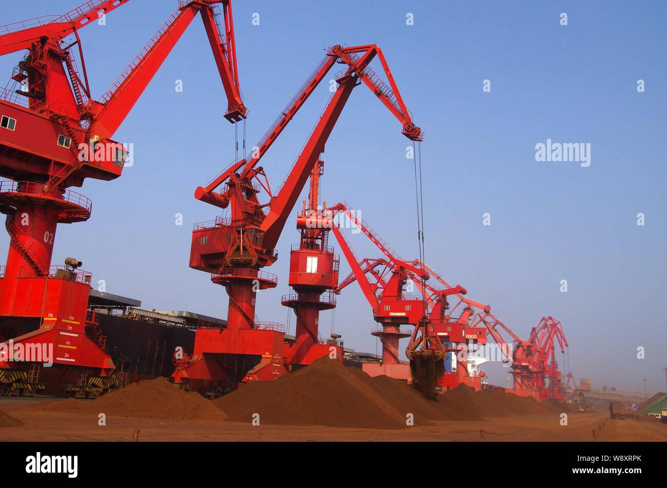 --FILE--Grab buckets unload iron ore on a quay at the Port of Rizhao in ...