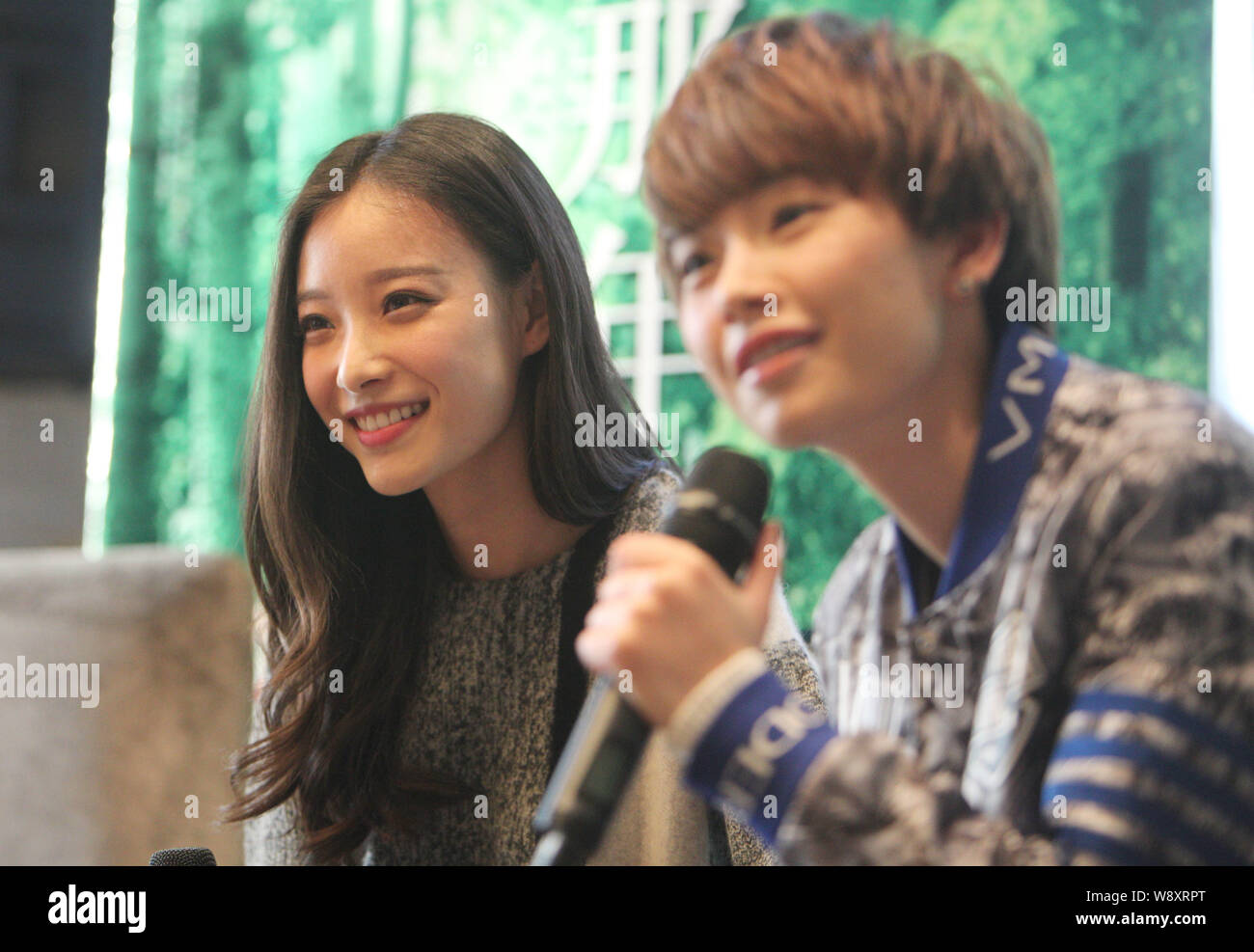 Chinese actress Ni Ni, left, smiles as singer Liu Yase speaks at a ...