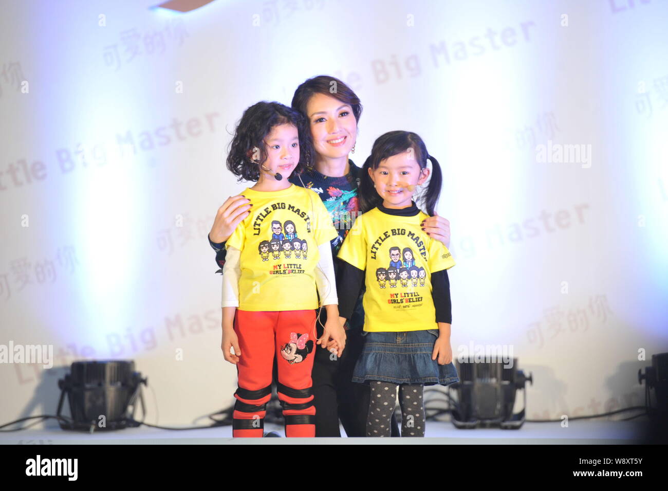 Hong Kong actress Miriam Yeung, center, poses with two children during ...
