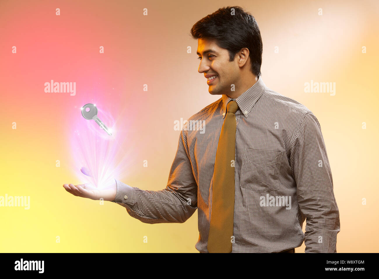 Businessman holding a glowing key Stock Photo - Alamy