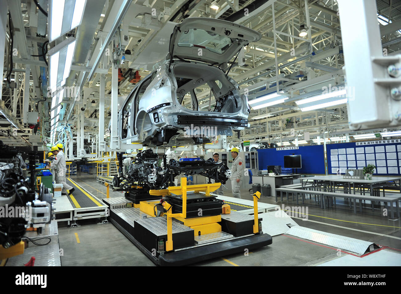 Chinese workers assemble a car at a plant of the Dongfeng Nissan Dalian ...