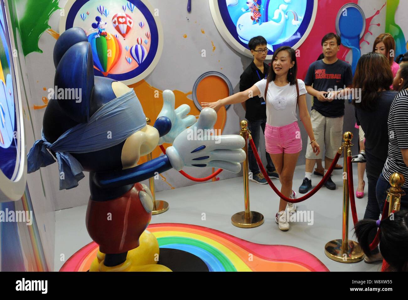 Visitors look at a statue of Disney figure Mickey Mouse during the Walt ...