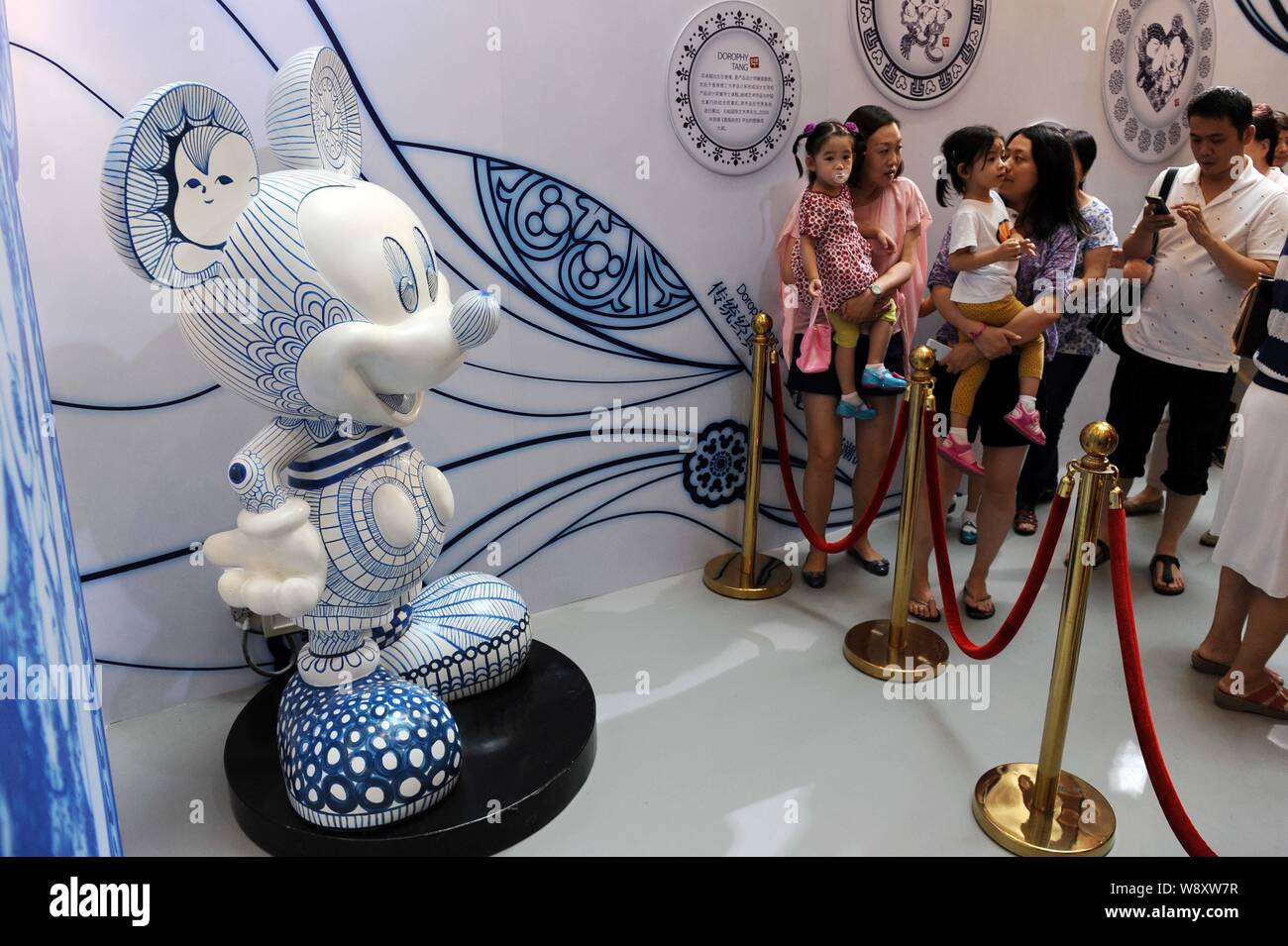 Visitors look at a statue of Disney figure Mickey Mouse during the Walt ...