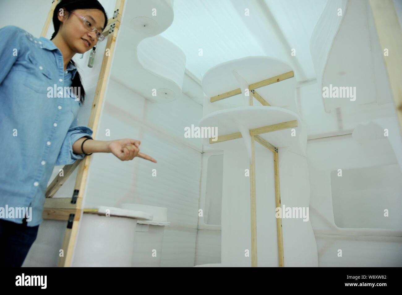 A student shows a 4-square-meters house prototype at Yangzhou ...
