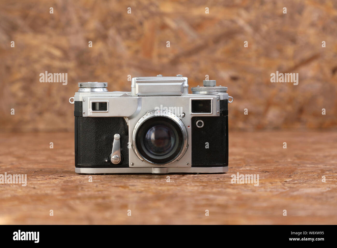Old vintage film camera on brown textured background Stock Photo - Alamy