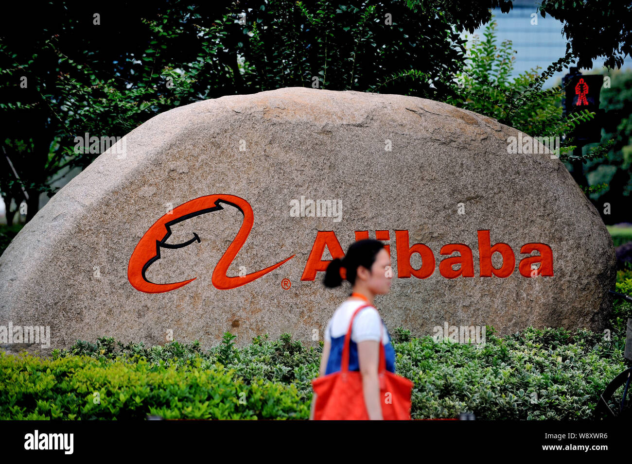 --FILE--A Chinese employee enters the headquarters of Alibaba Group in ...