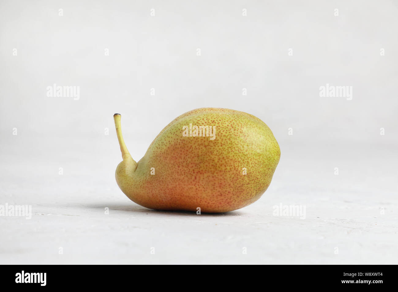 Ugly vegetables , ripe green pear of bizarre shape , on a white ...