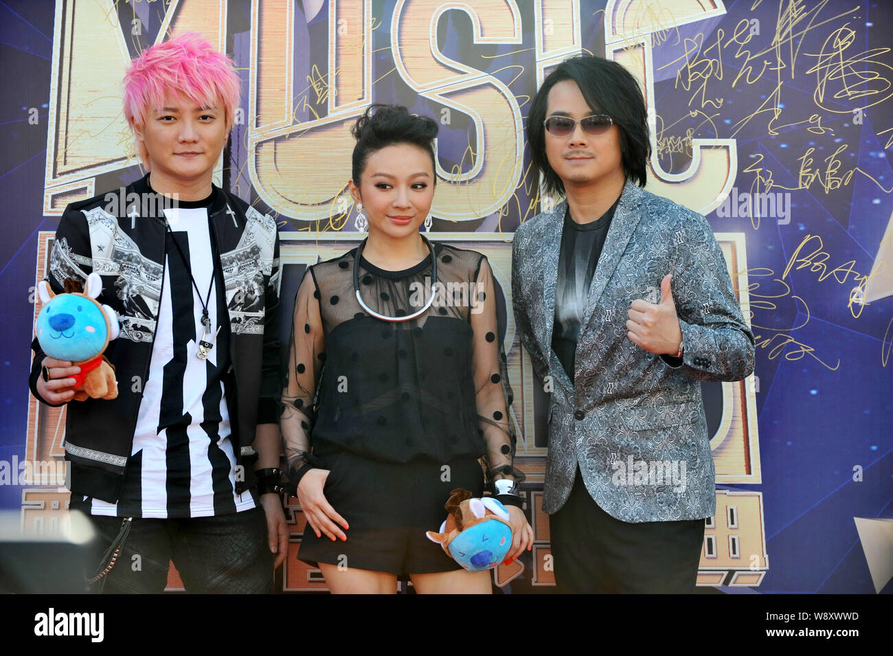 Members of Taiwanese band F.I.R. pose on the red carpet as they arrive ...