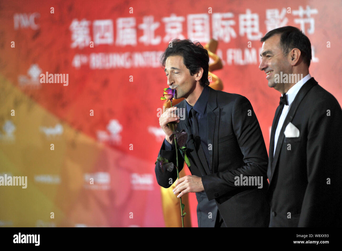 American actor Adrien Brody, left, kisses a rose on the red carpet for ...