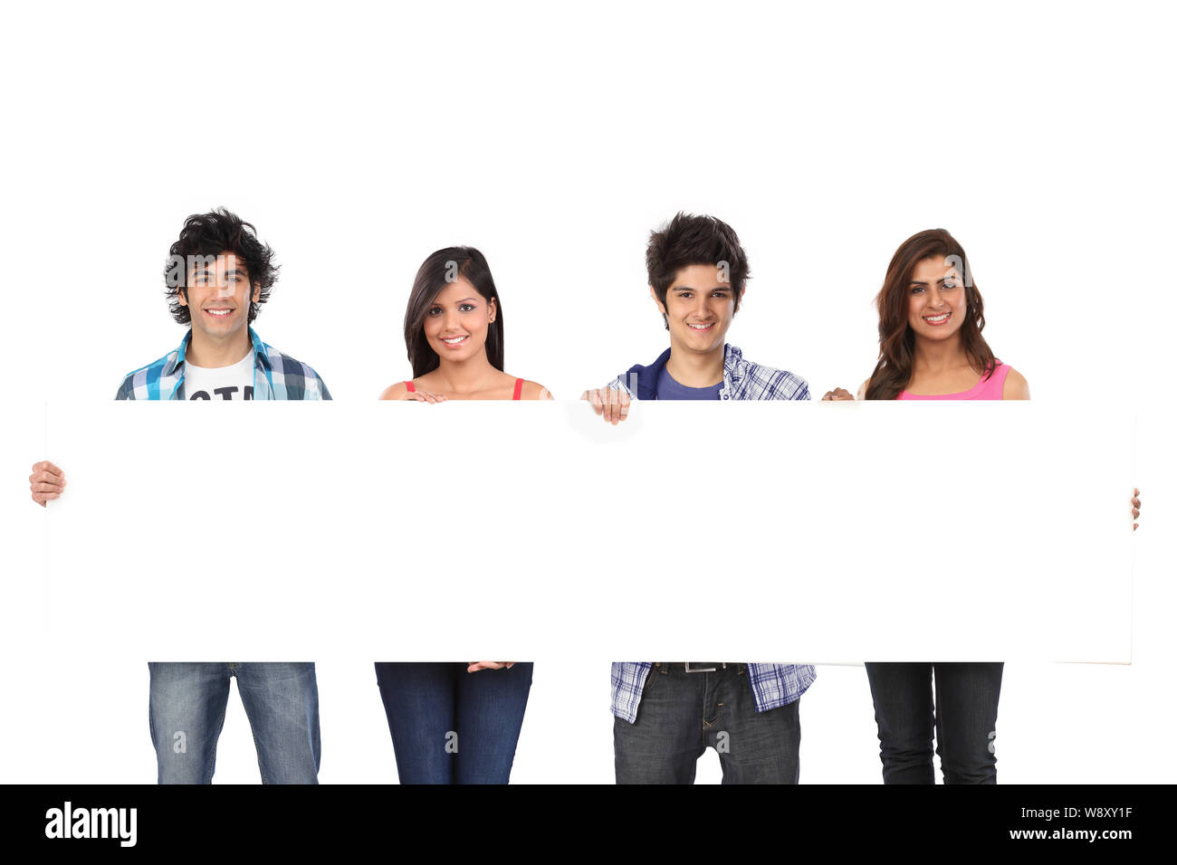 Group of friends holding a blank placard and smiling Stock Photo - Alamy