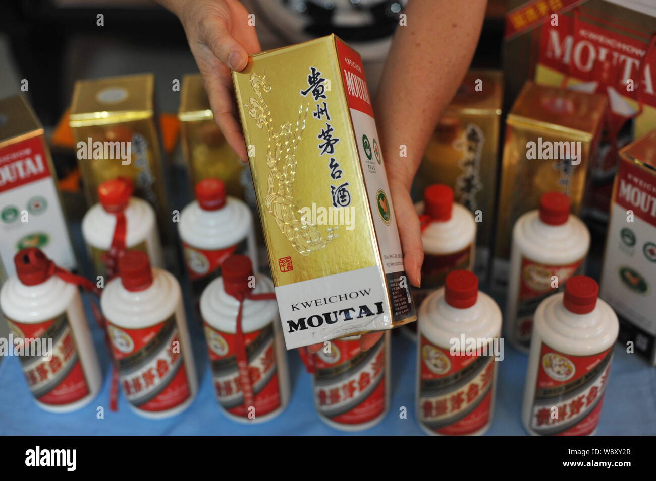 --FILE--A clerk shows bottles of Kweichow Moutai liquor at a store in ...