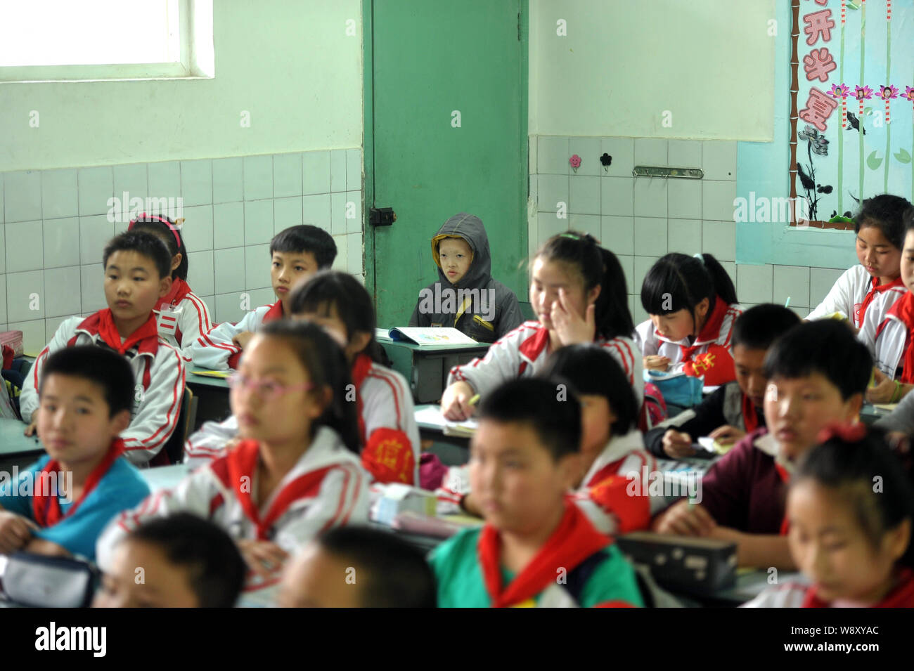 Liu Liangchen, back, who wraps himself up with preservative film because of a rare skin disease ...