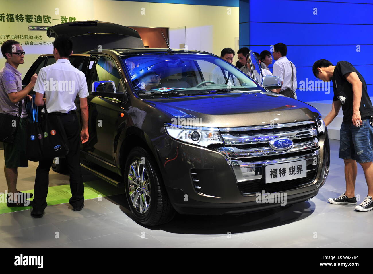 --FILE--Visitors look at a Ford Edge SUV during an automobile ...