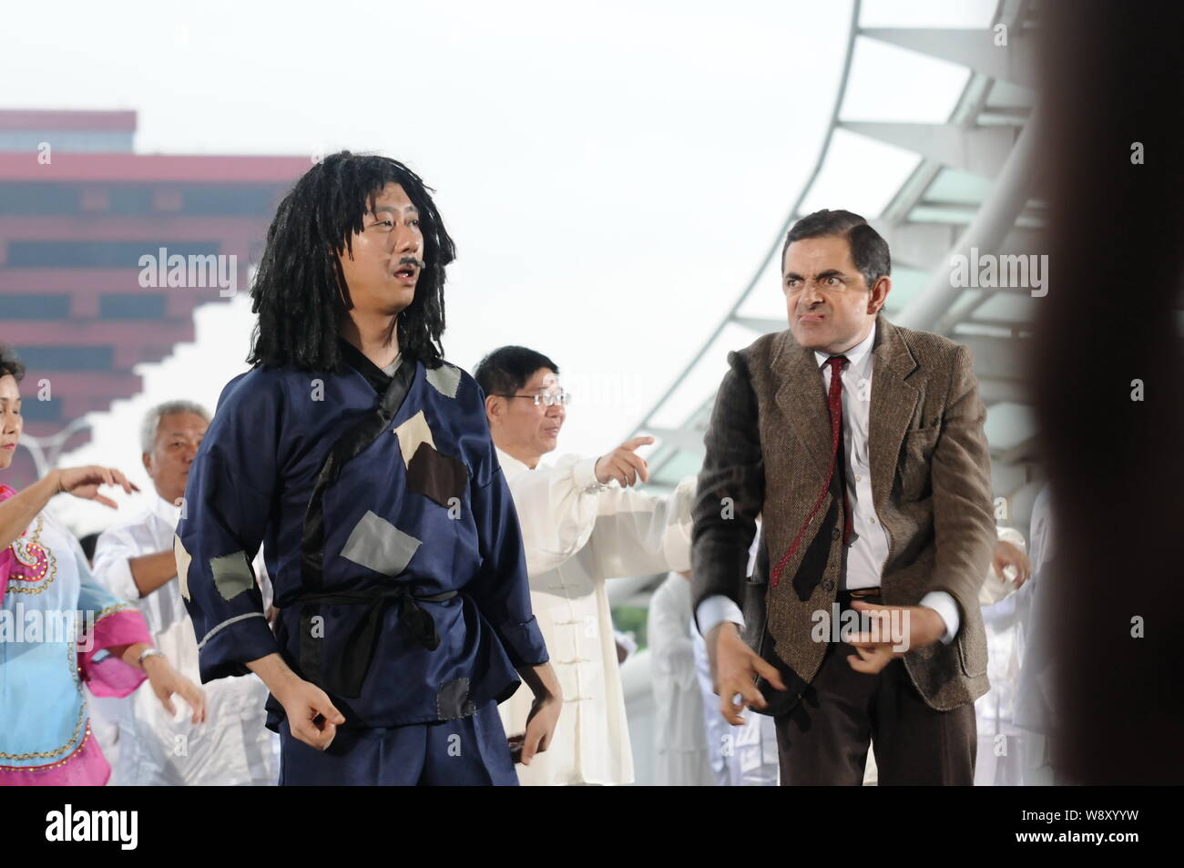 English actor Rowan Atkinson, right, plays Mr. Bean during a filming session for a TV commercial ...