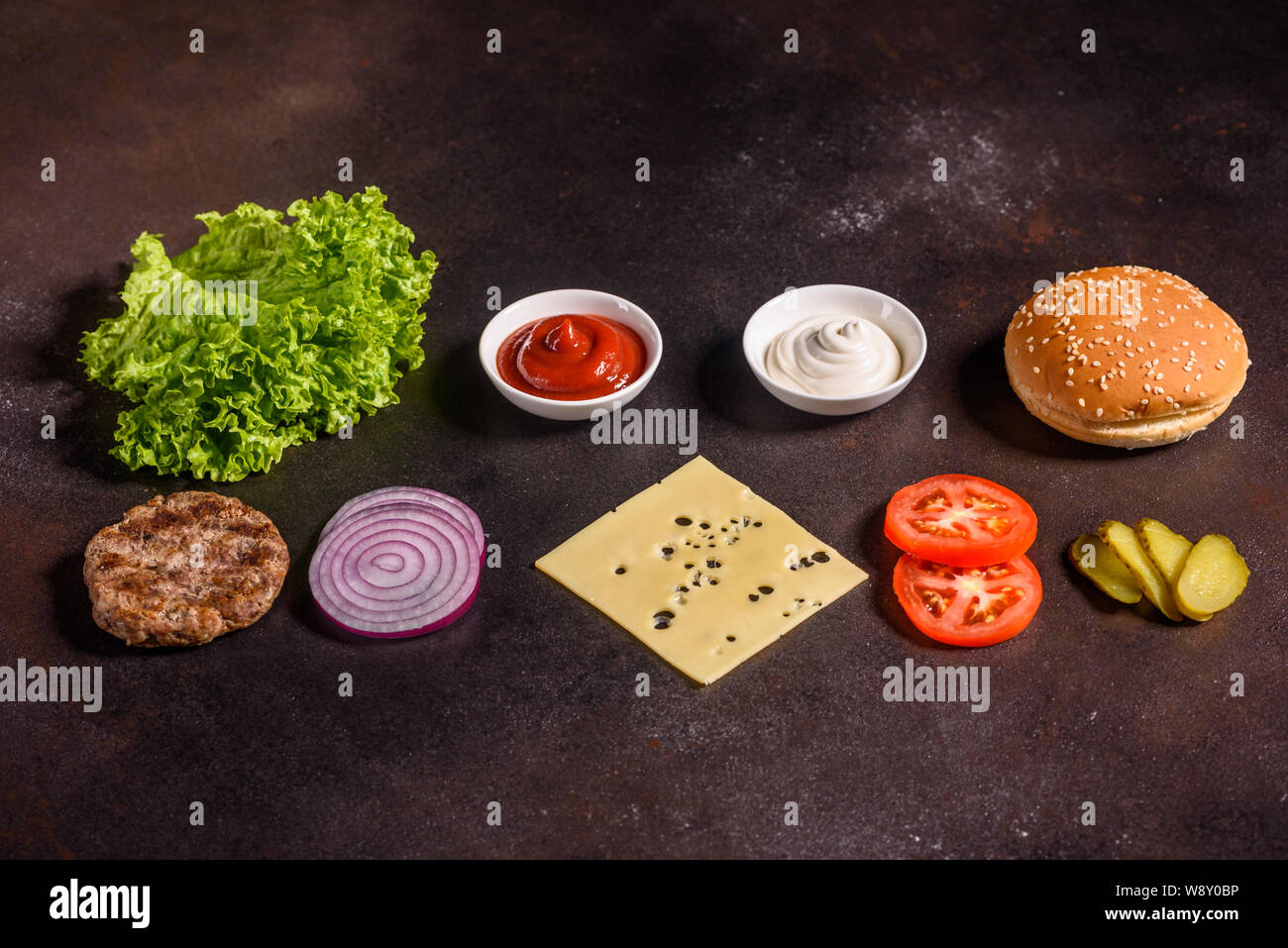 Burger ingredients on the dark background. Top view Stock Photo - Alamy