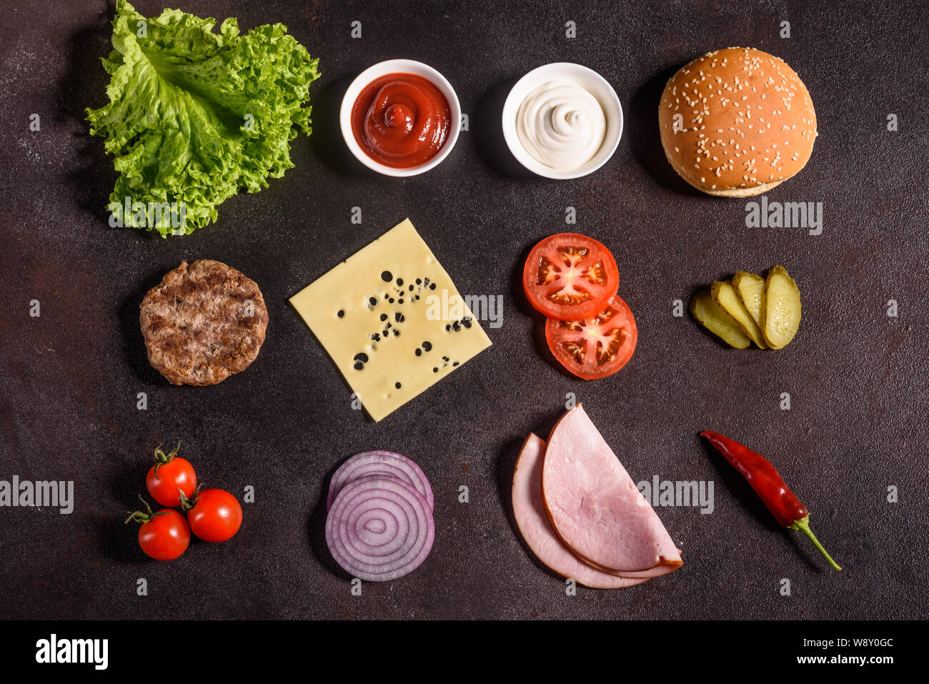Burger ingredients on the dark background. Top view Stock Photo - Alamy