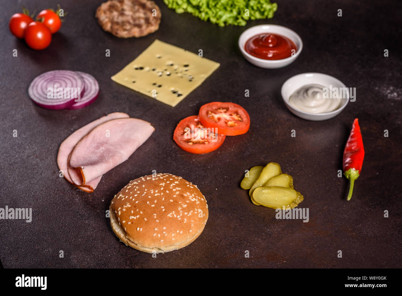 Burger ingredients on the dark background. Top view Stock Photo - Alamy
