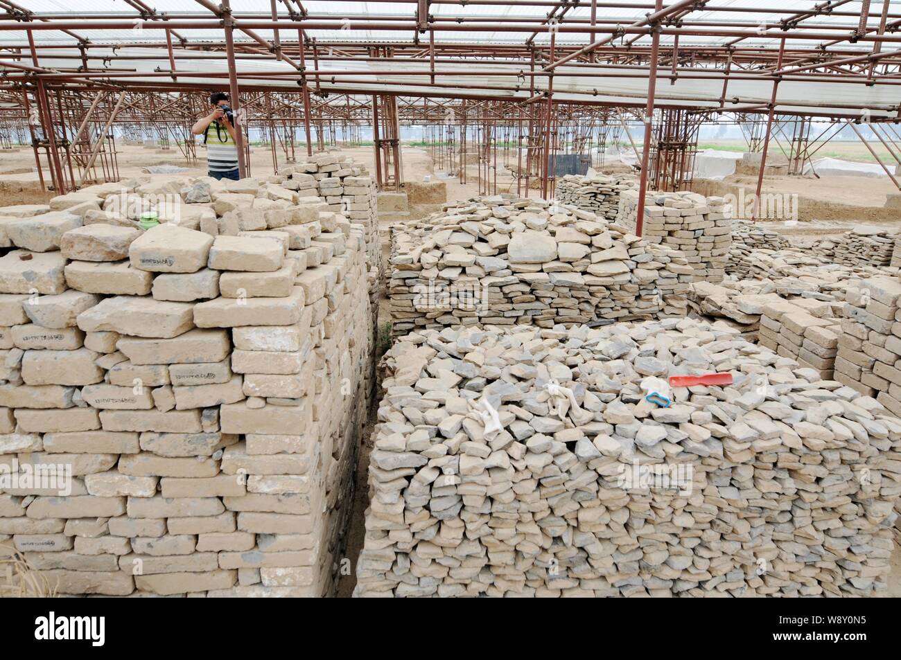 --FILE--A visitor takes photos at the excavation site where the Taiji ...