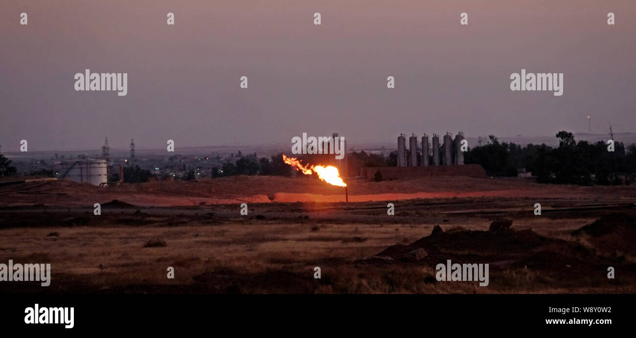 Hydrogen sulfide burns off as it leaves a pipe at an oil field near ...