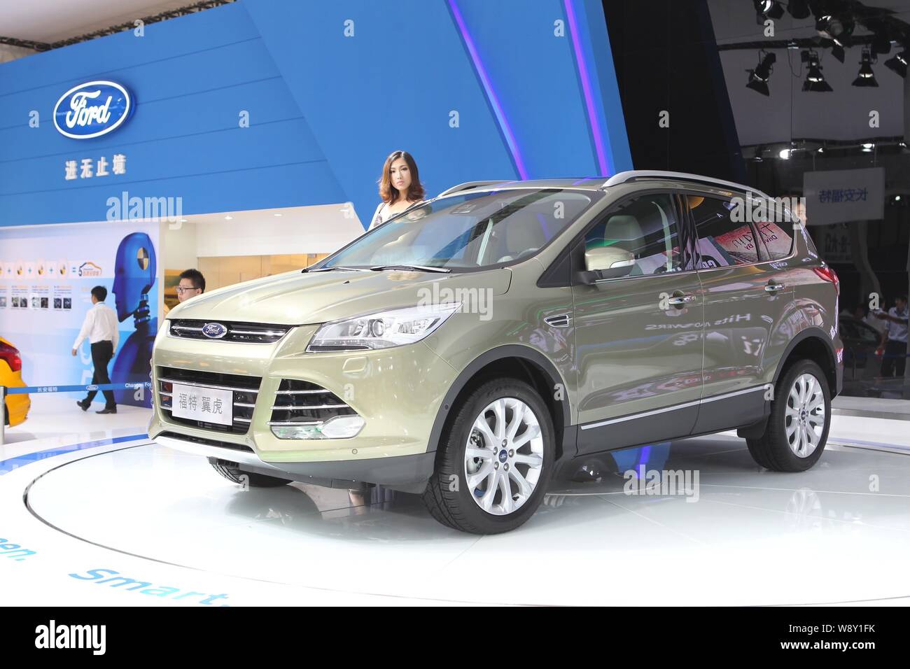 --FILE--A model poses with a Ford Kuga during an auto show in Shanghai ...