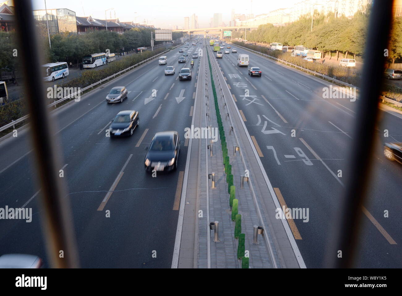 Cars travel on an uncrowded road which is usually jammed with traffic ...