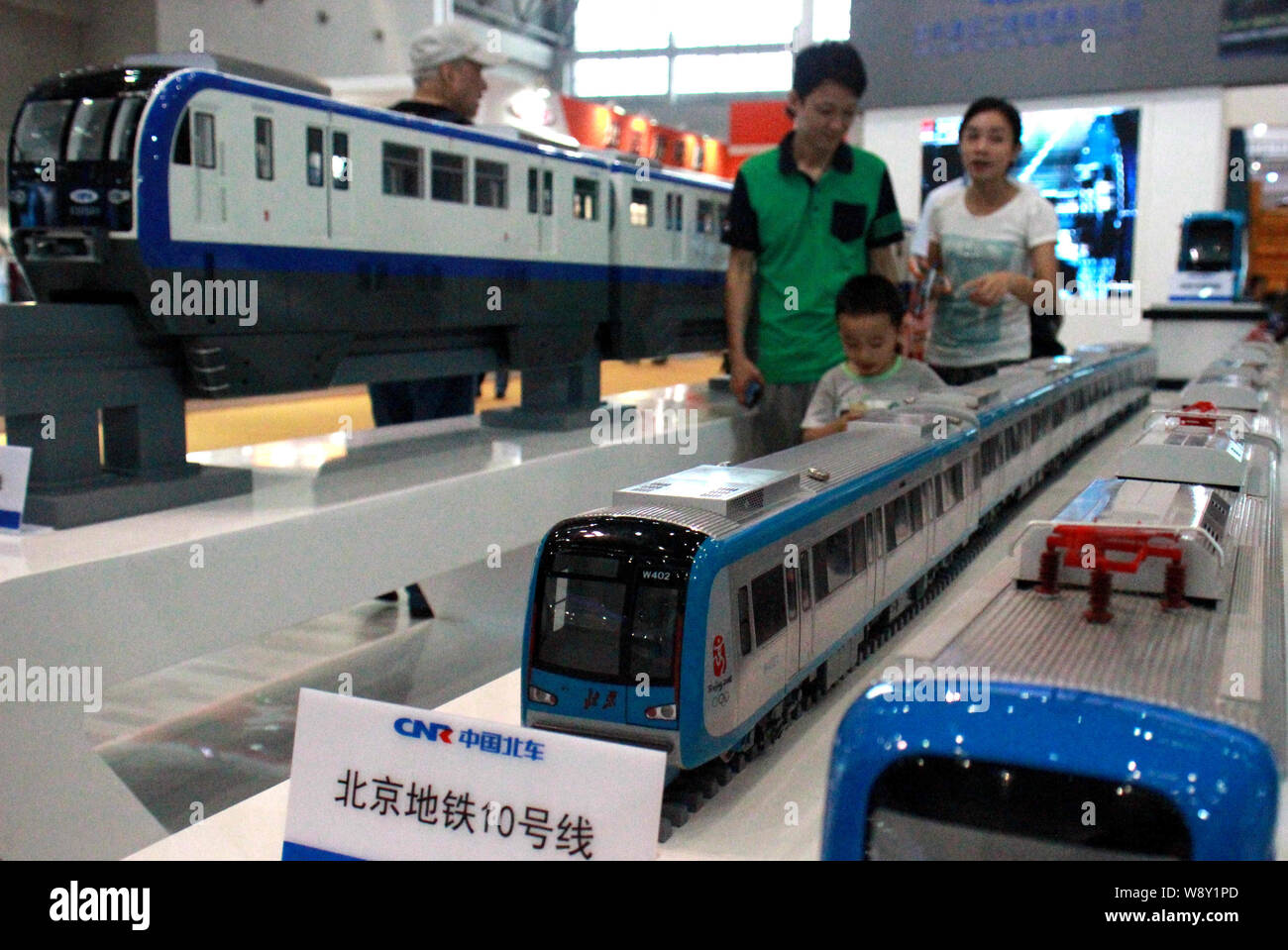 --FILE--Visitors look at model subway trains at the stand of CNR (China ...