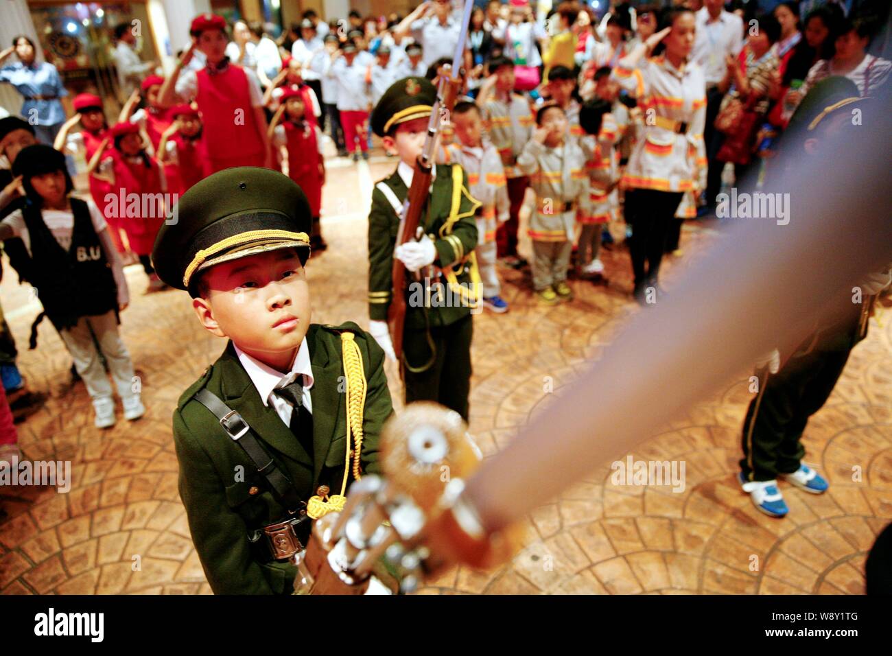 Young kids dressed in Chinese paramilitary policeman uniforms stand ...