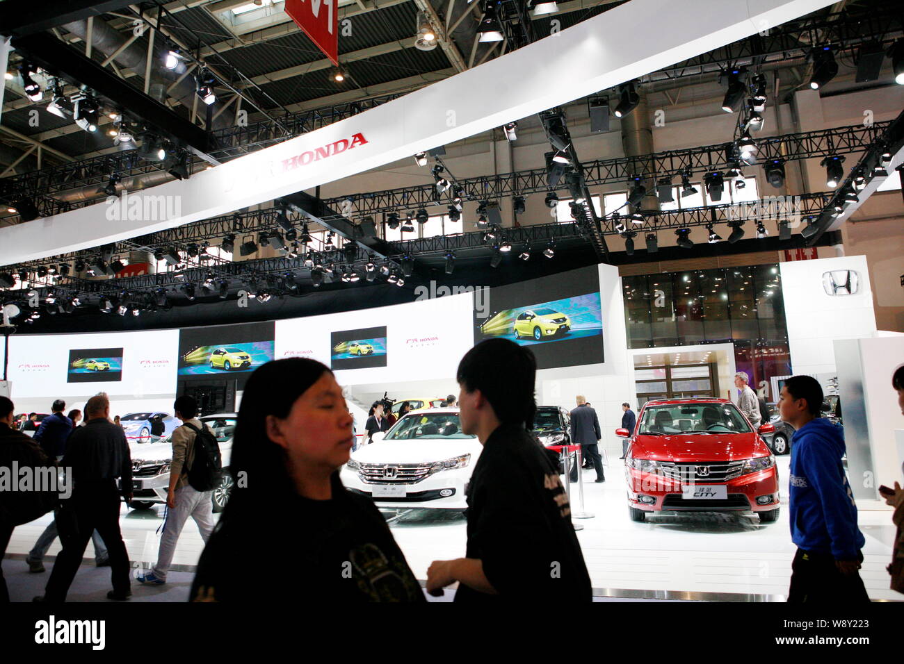 --FILE--Visitors walk past the stand of Honda during the 13th Beijing ...
