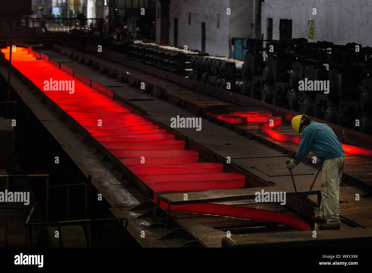 --FILE--A Chinese worker surveys the production of steel at a steel ...