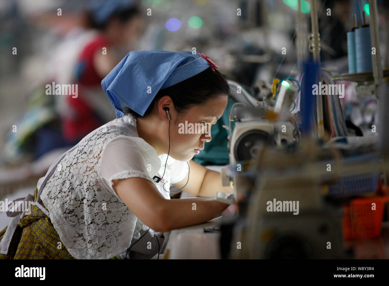 A female Chinese worker sews clothes to be exported to Europe at a garment factory in Huaibei ...