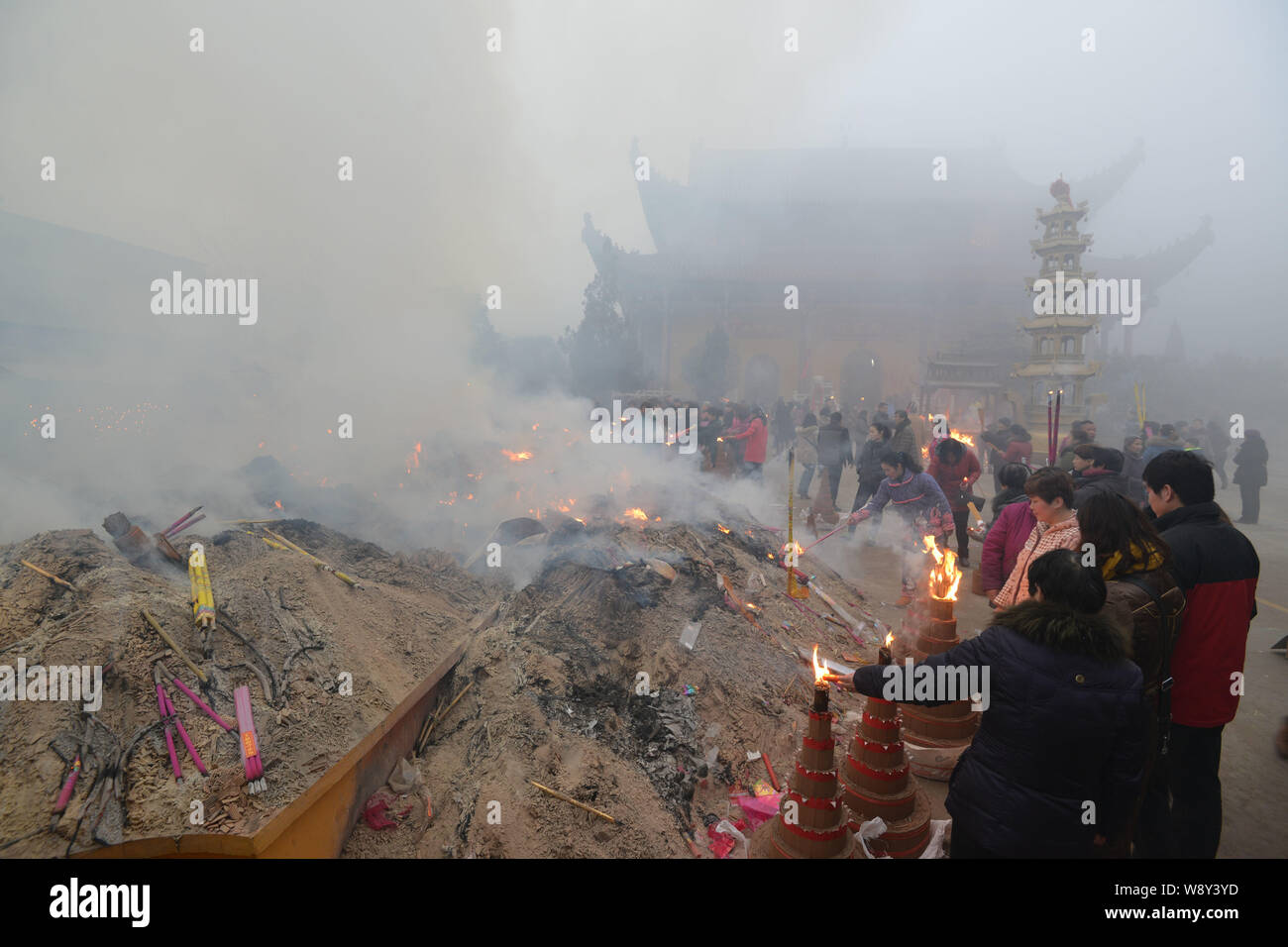 Chinese worshippers burn incense sticks to pray for good fortune and ...
