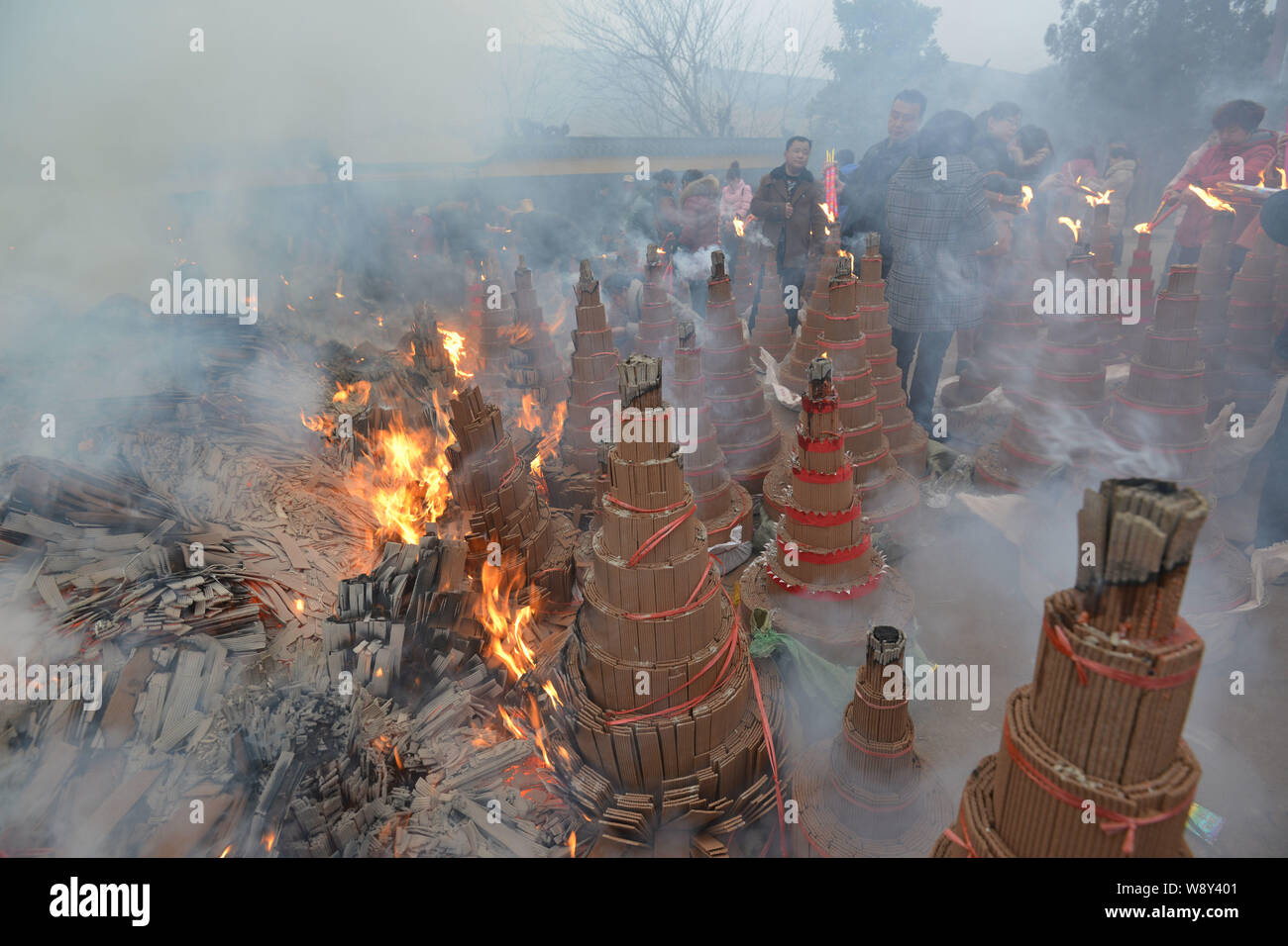 Chinese worshippers burn incense sticks to pray for good fortune and ...