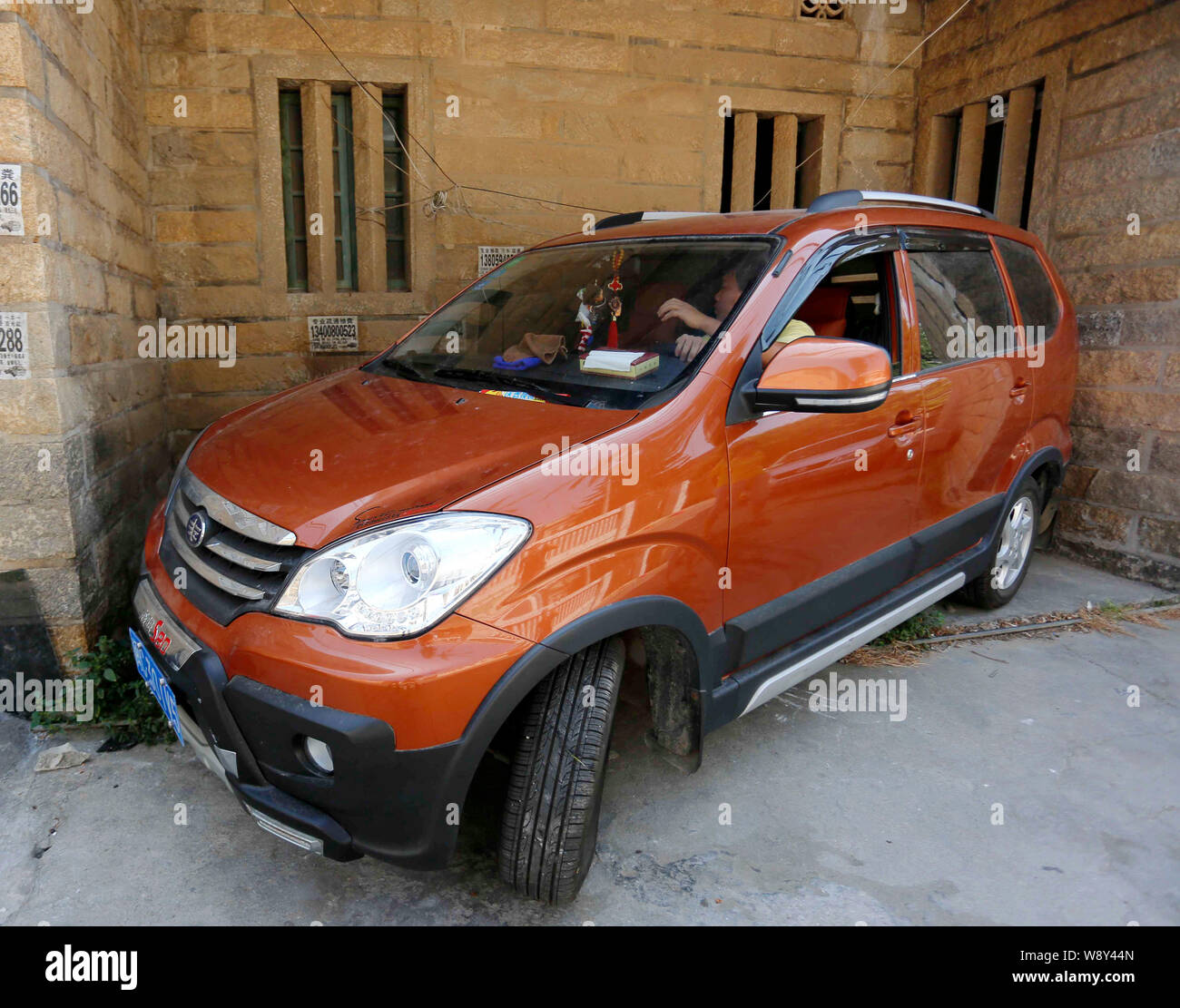 Chinese driver Chen Zhongliang demonstrates pulling his car out of a ...
