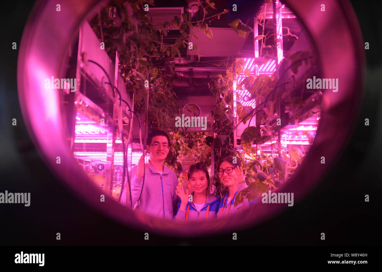 Captain Xie Beizhen, center, and her crew members Dong Chen, left, and Wang Minjuan wave inside ...