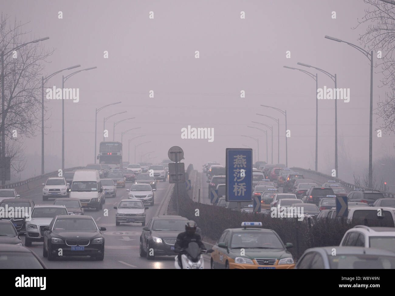 Masses of vehicles travel on a road in heavy smog in Beijing, China, 20 ...