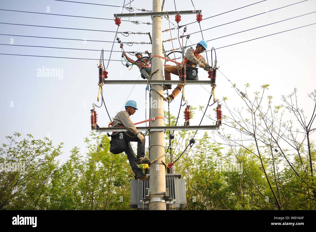 --FILE--Chinese electricians check high-voltage power lines in a ...
