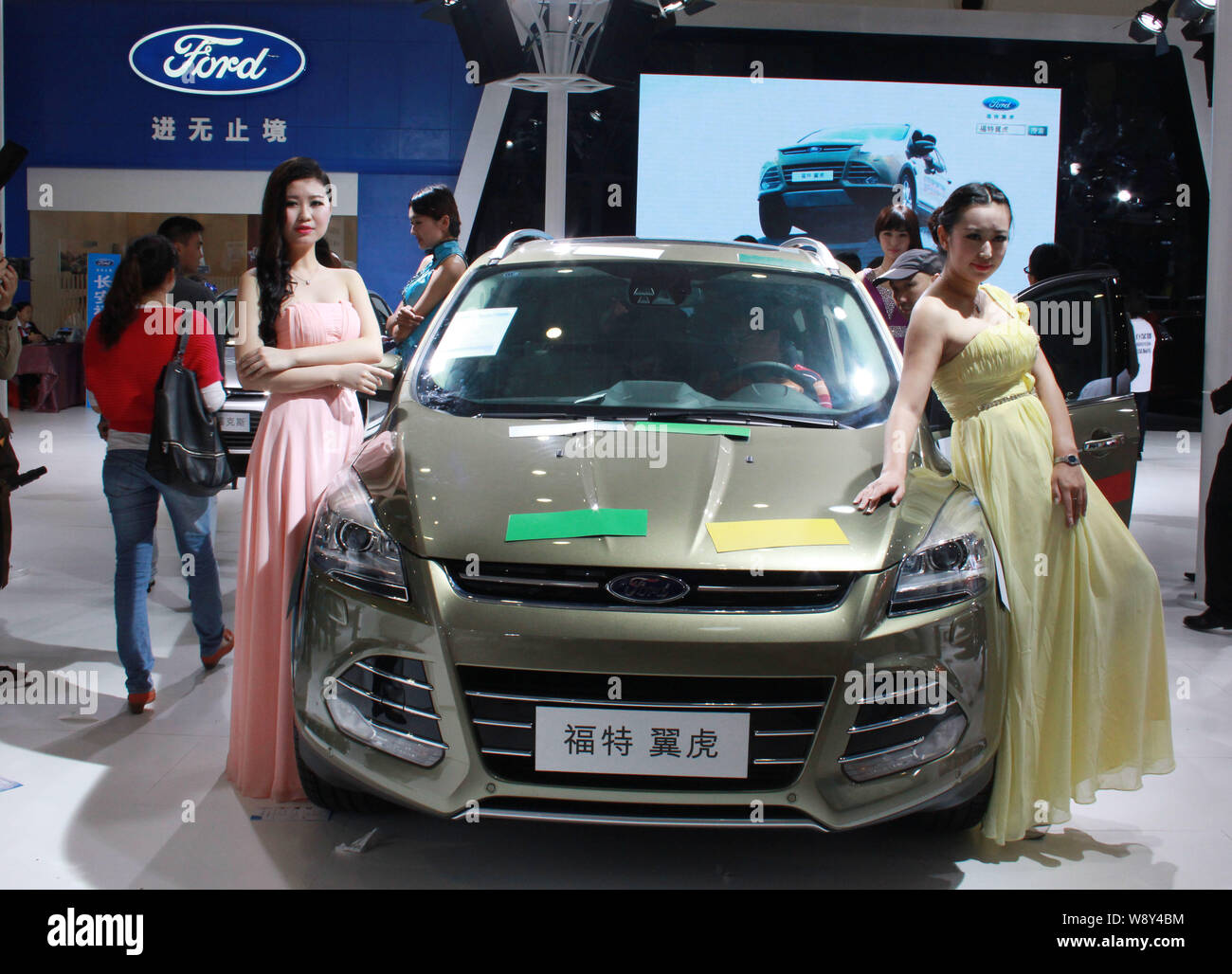 --FILE--Models pose with a Ford Kuga during an auto show in Haikou city ...