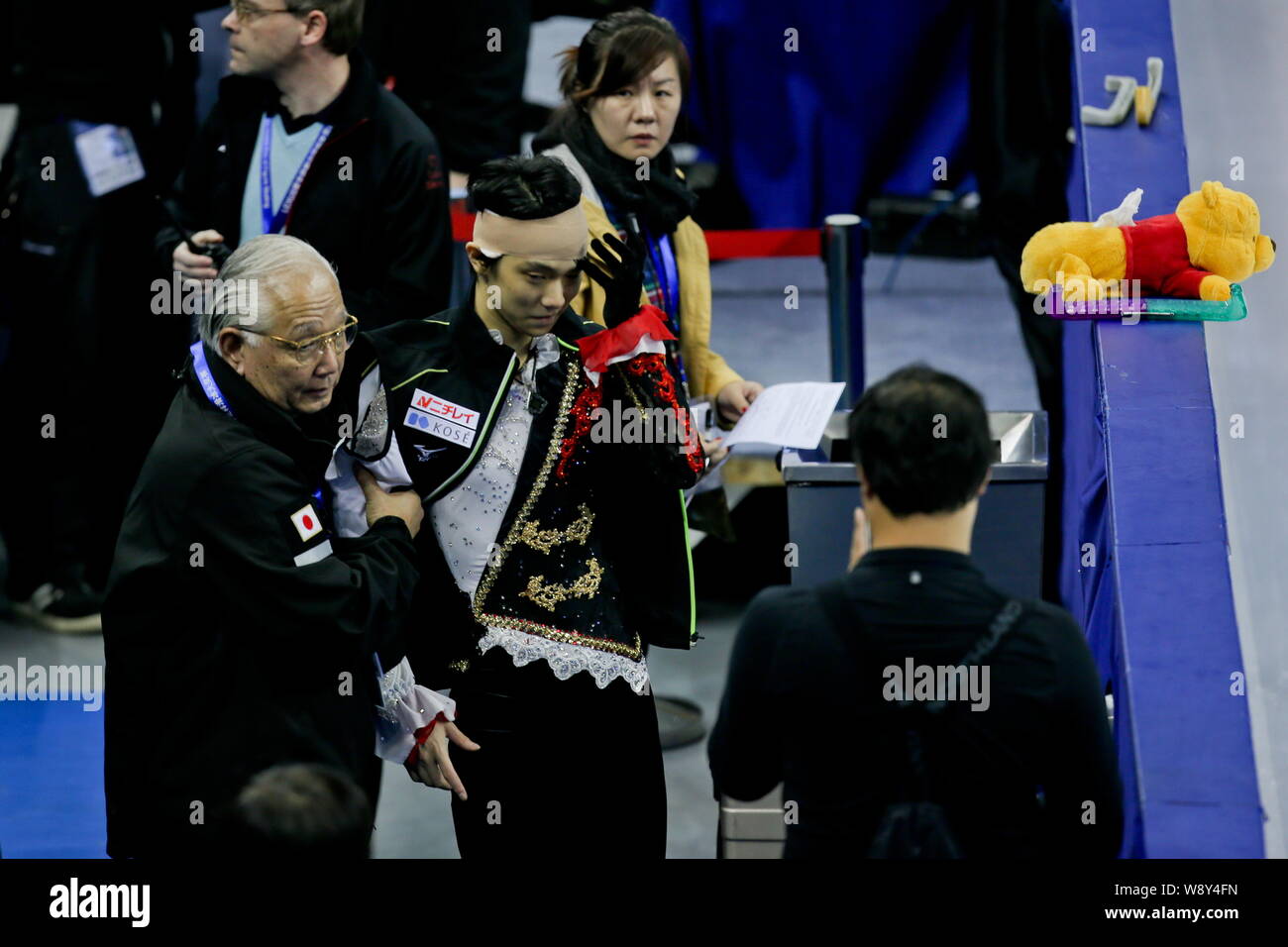 Hanyu Yuzuru of Japan, center, who is injured after colliding with Yan ...