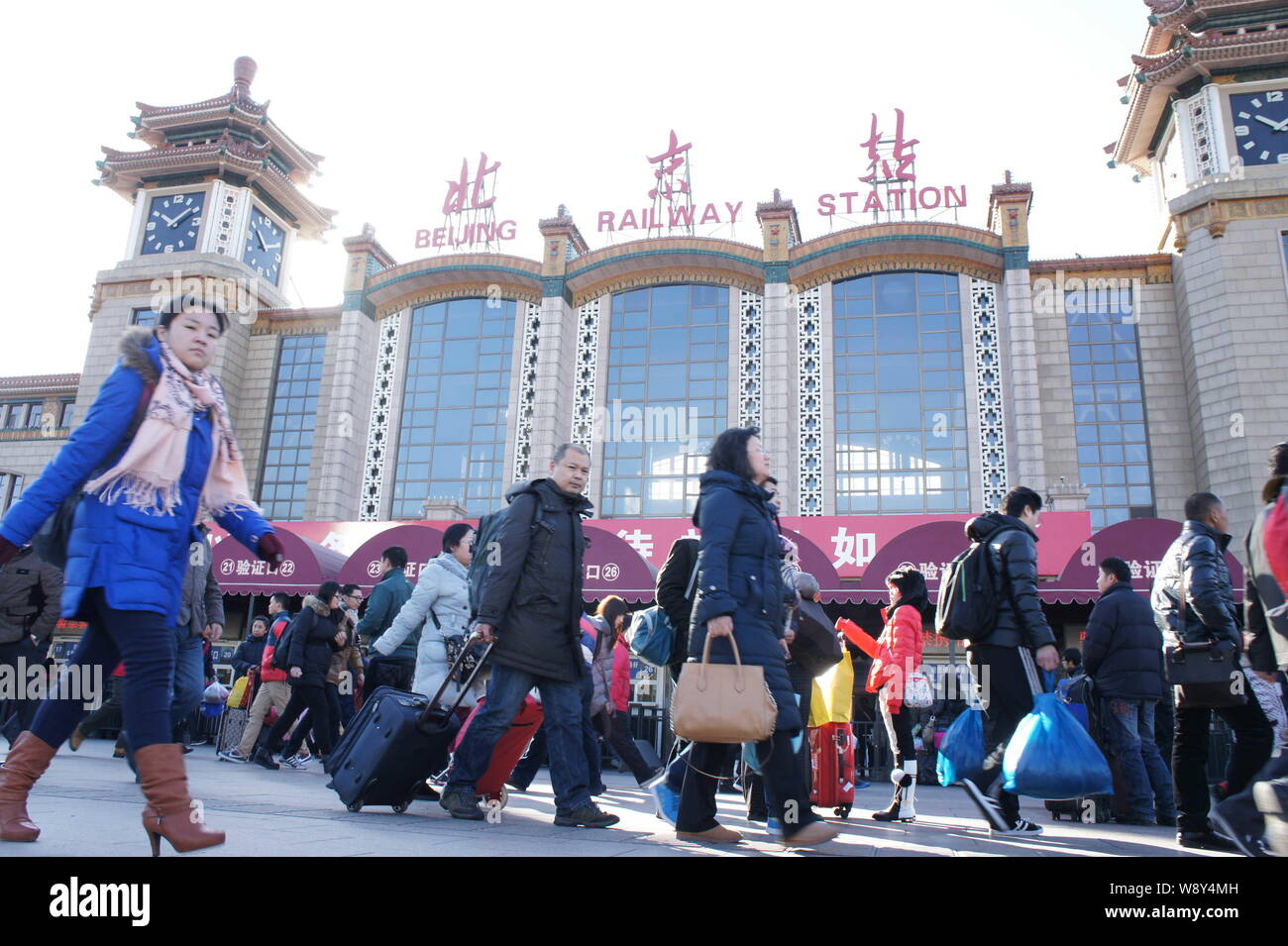 Chinese passengers walk past the Beijing Railway Station during the ...