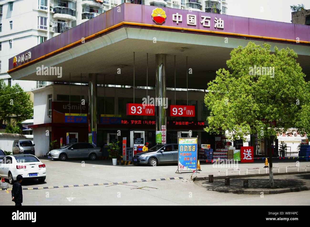 --FILE--Cars are being refueled at a gas station of PetroChina, a ...