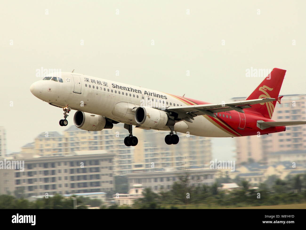 --FILE--A plane of Shenzhen Airlines takes off at the Sanya Phoenix ...