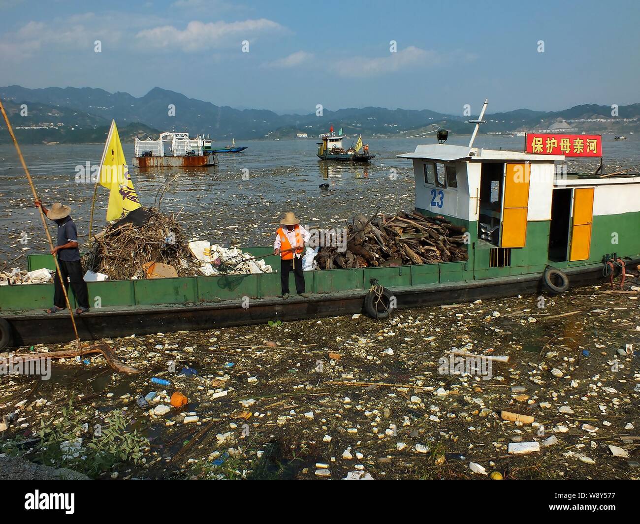 Chinese workers collect garbage floating on the Yangtze River in the ...