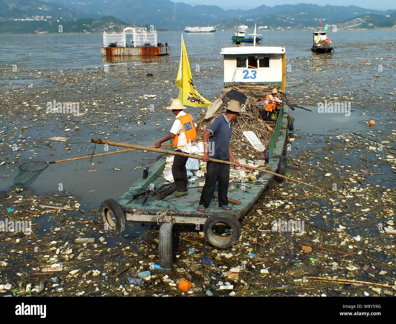 Chinese workers collect garbage floating on the Yangtze River in the ...