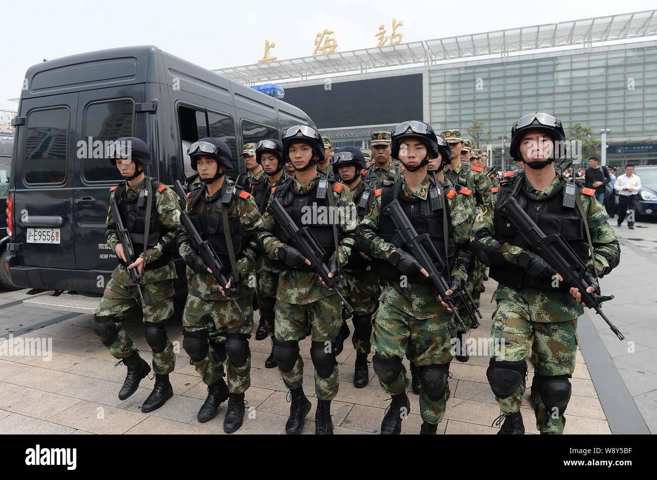 SWAT police officers armed with guns patrol at the square of the ...
