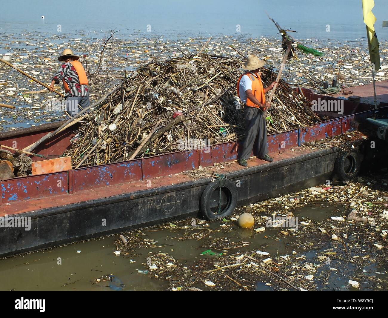 Chinese workers collect garbage floating on the Yangtze River in the ...