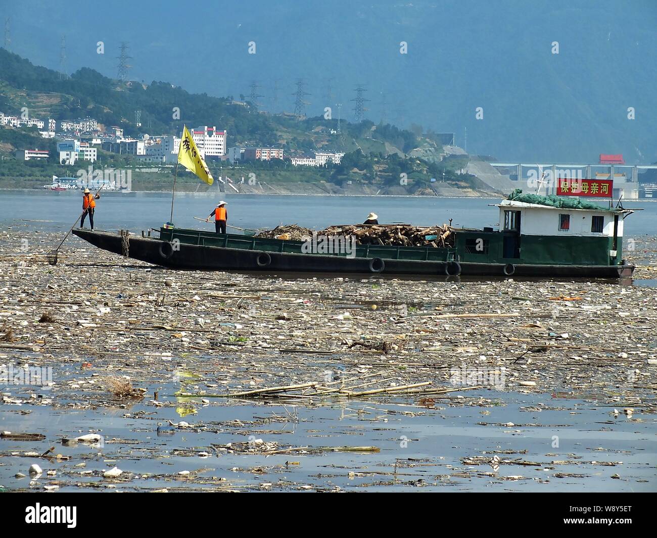 Chinese workers collect garbage floating on the Yangtze River in the ...