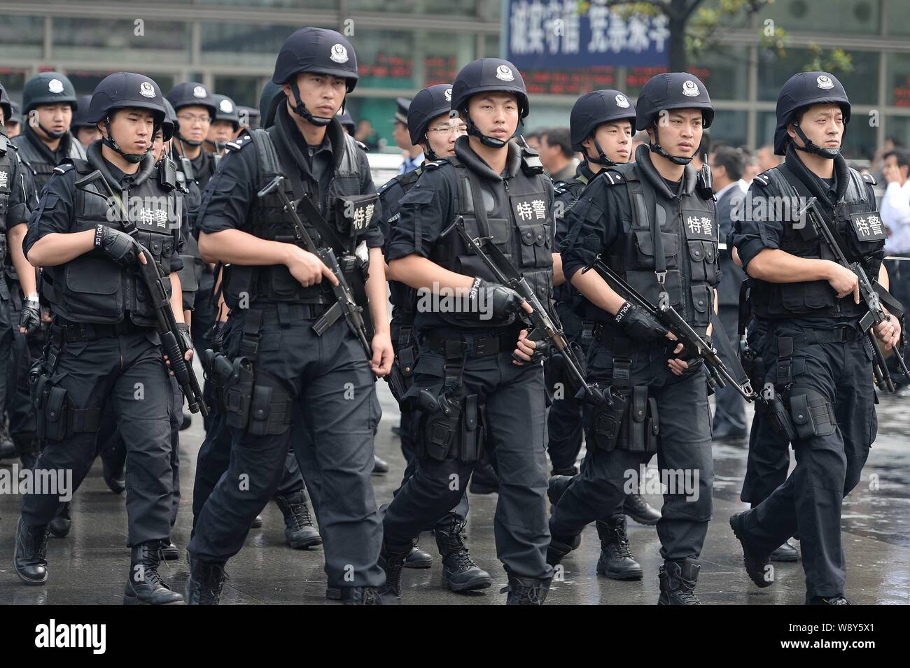 SWAT police officers armed with guns patrol at the square of the ...
